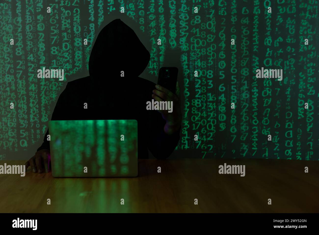 Hacker using cell phone for hacking Stock Photo - Alamy