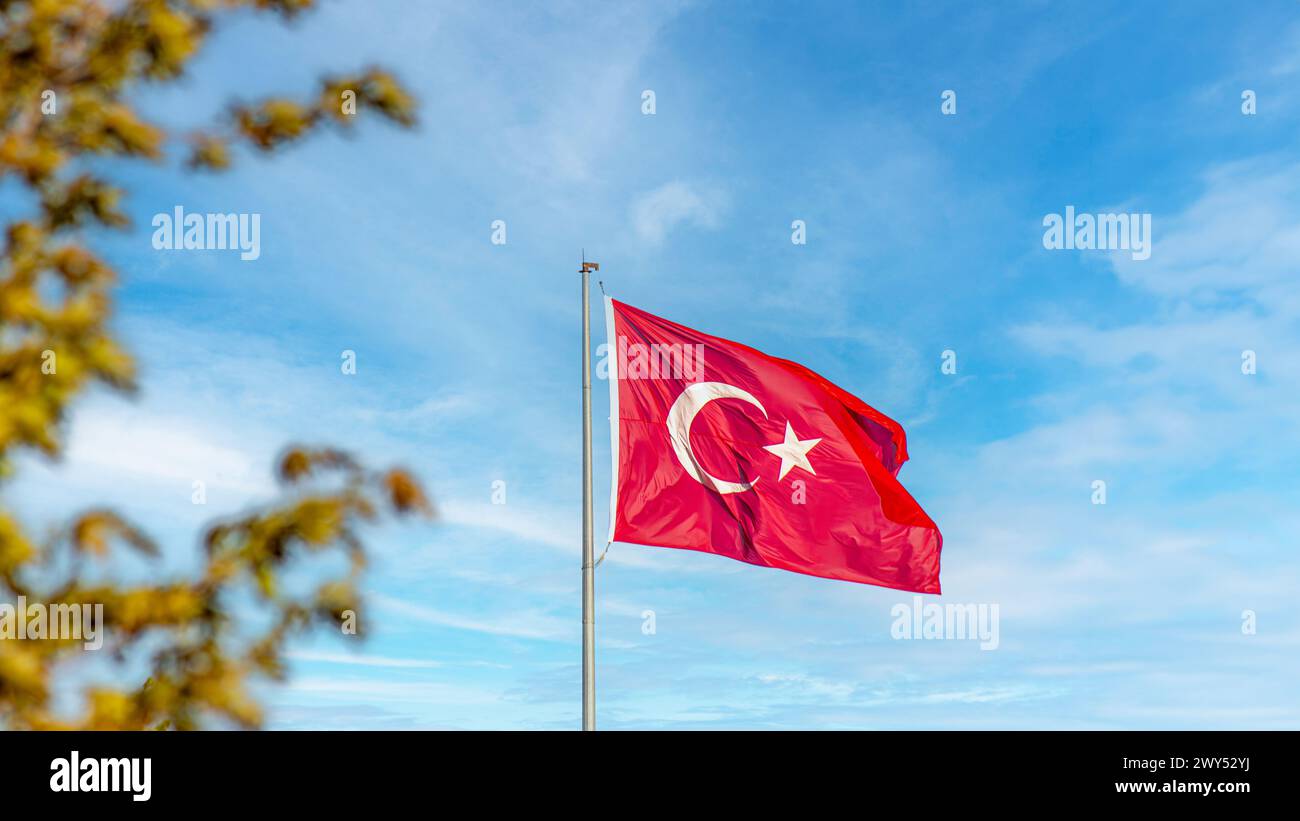 Turkish flag waving with pride against a backdrop of blue skies Stock ...