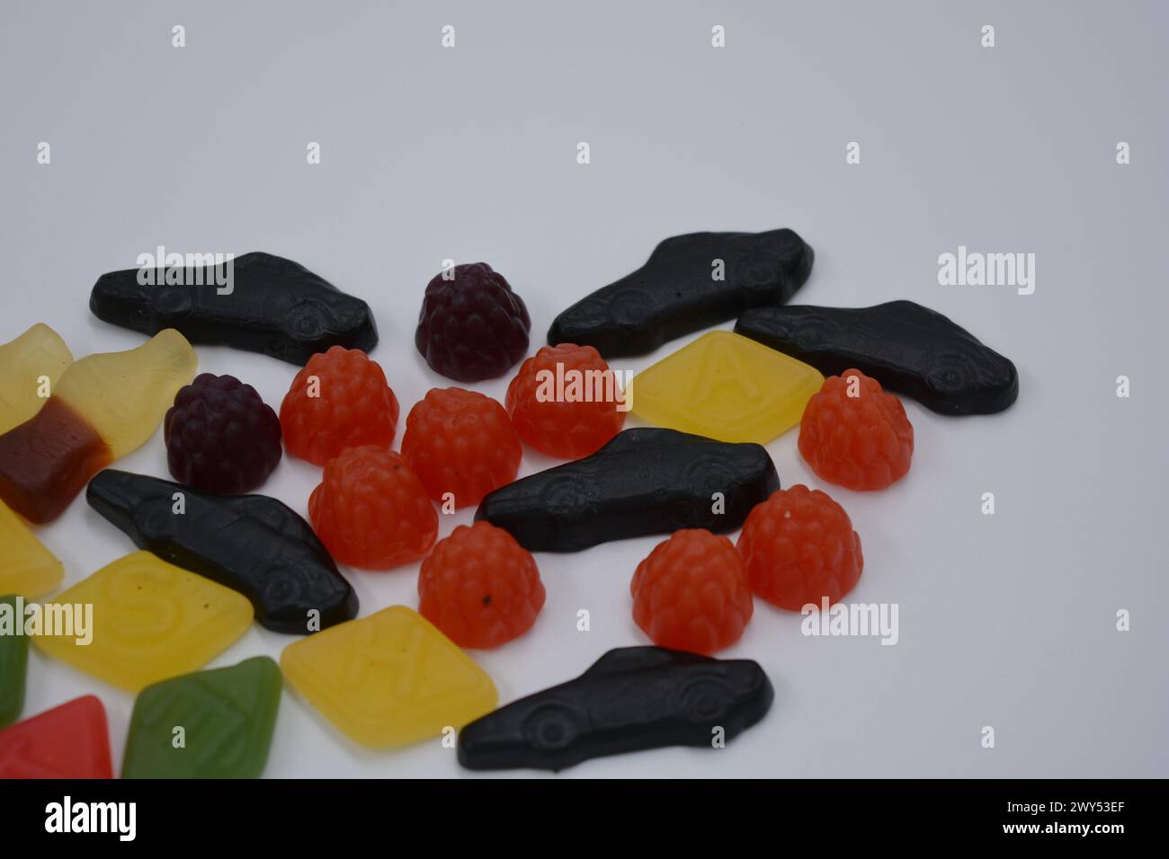 Candies in the form of a black car, raspberries, blackberries, cola ...