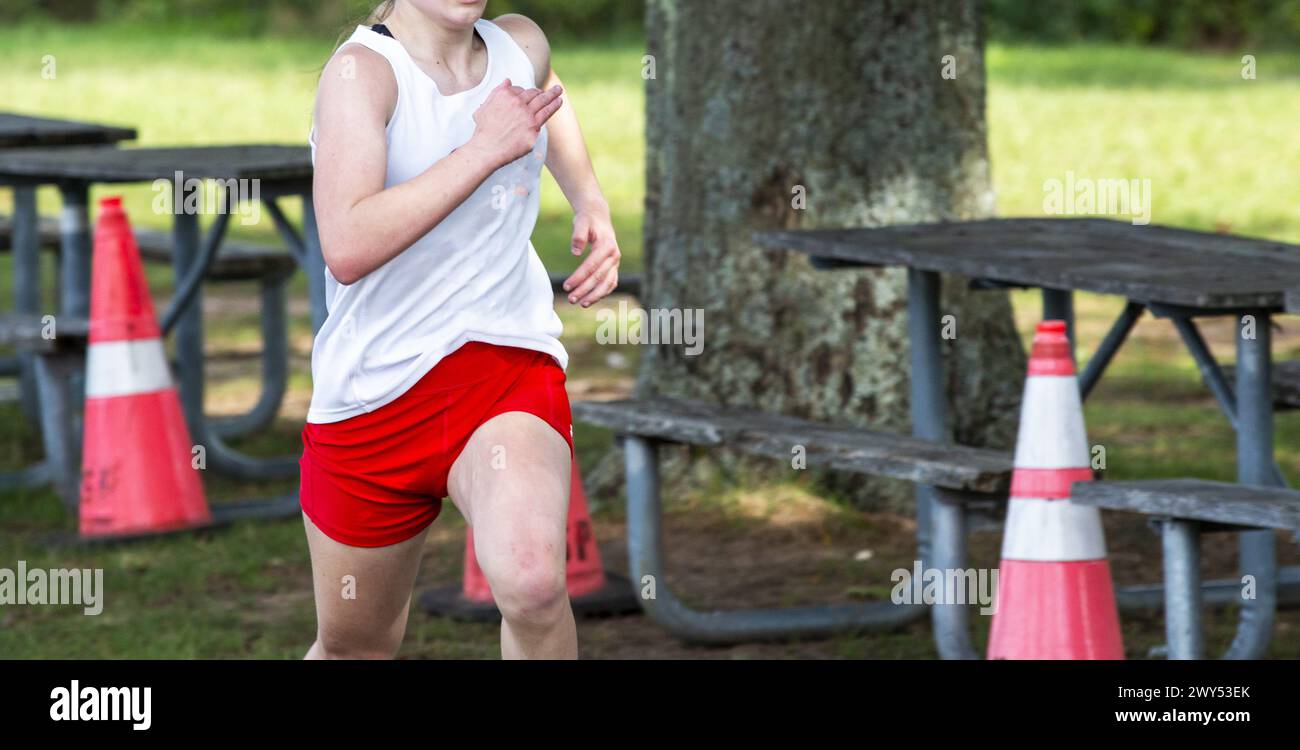 One Female cross country runner finishing a 5K in Sunken Meadow State ...