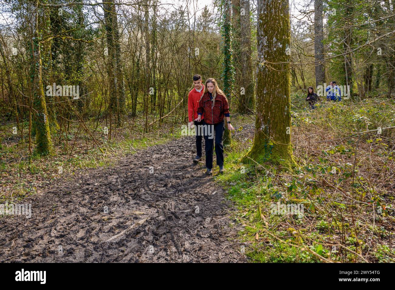 Young adults traversing an extremely muddy footpath between Haywards ... Young adults traversing an extremely muddy footpath between Haywards ...