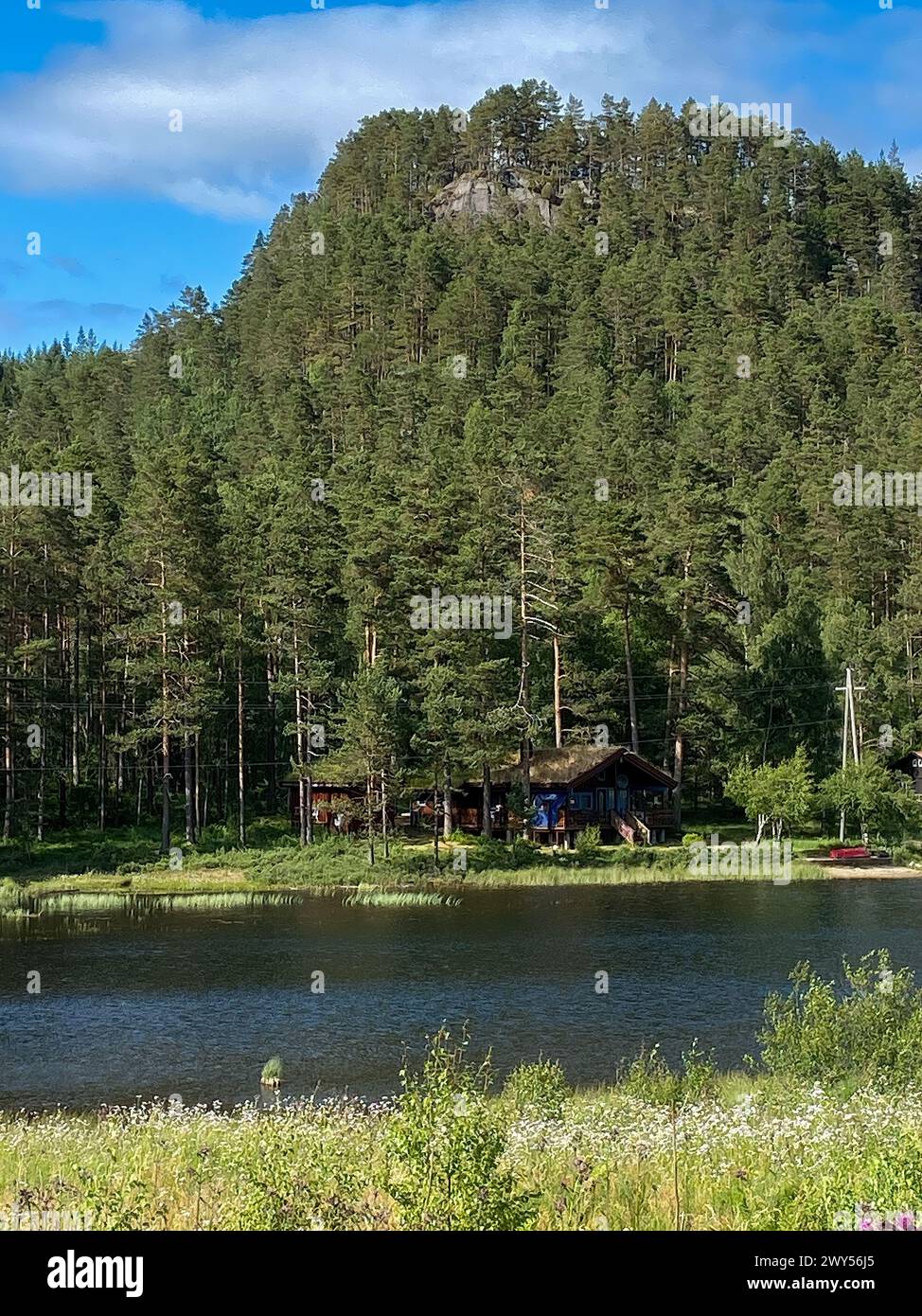 typical wooden log cabin in Norway in the forest by the lake Stock ...
