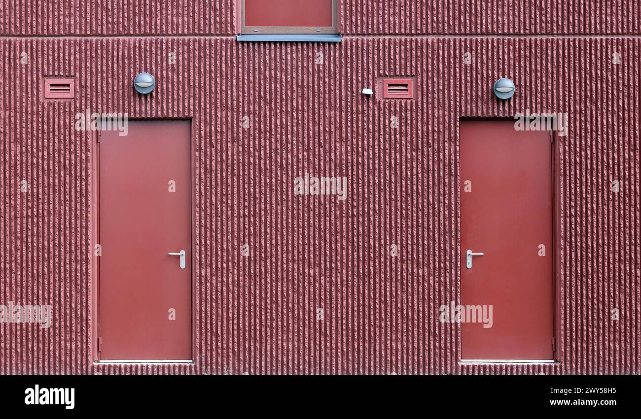 Two closed steel doors in a red wall Stock Photo - Alamy
