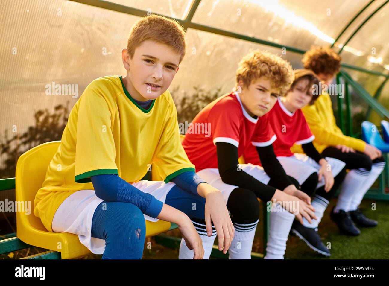 A tight-knit group of young men sitting closely together, conversing ...