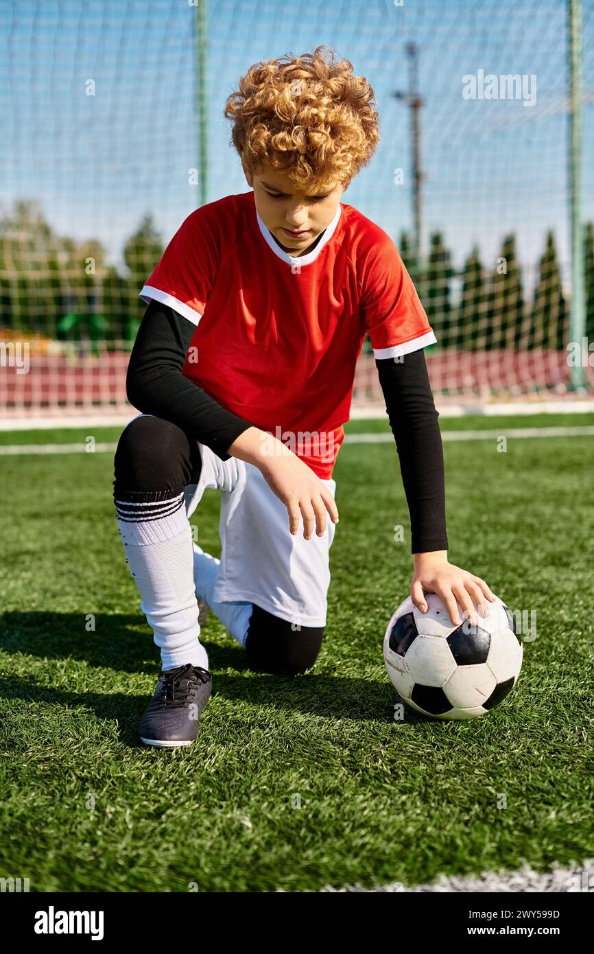 Boy picking up a ball hi-res stock photography and images - Alamy