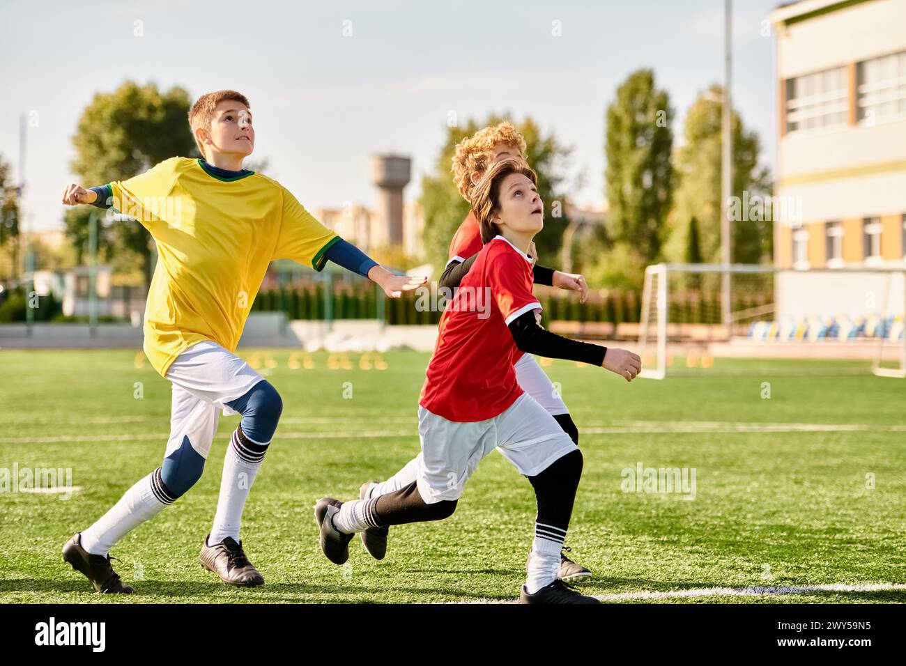 A spirited group of young men engage in an intense game of soccer, showcasing their skill ...