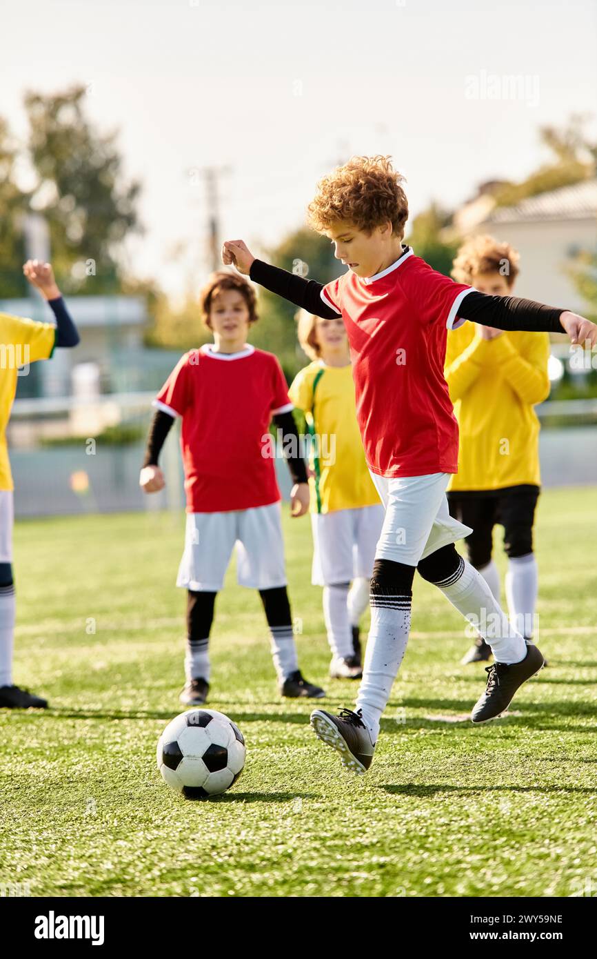 A group of children energetically playing soccer on a vibrant green ...