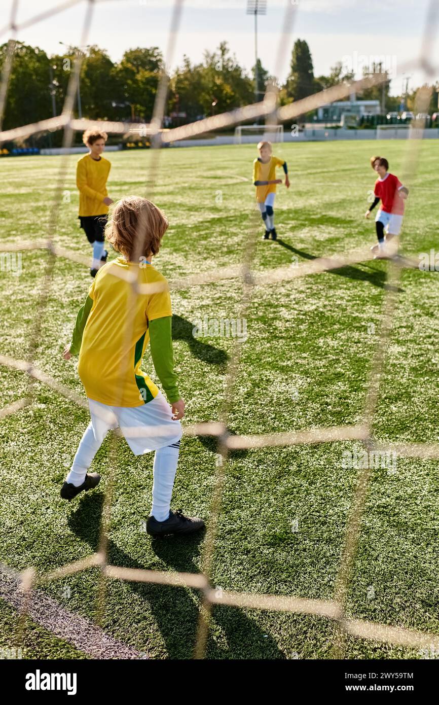 A group of young children play a spirited game of soccer on a bright ...
