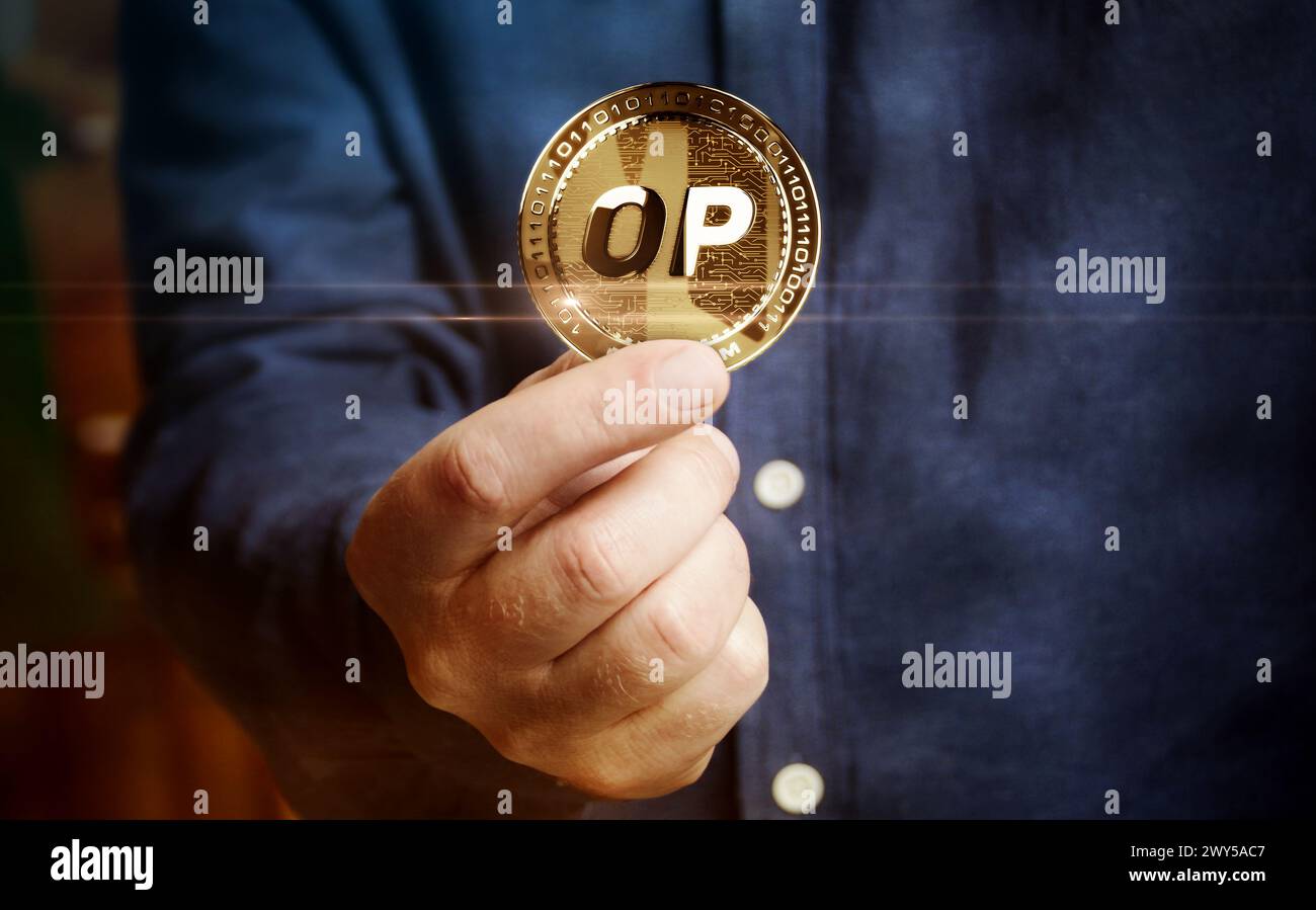 Optimism OP cryptocurrency golden coin in hand abstract concept Stock ...