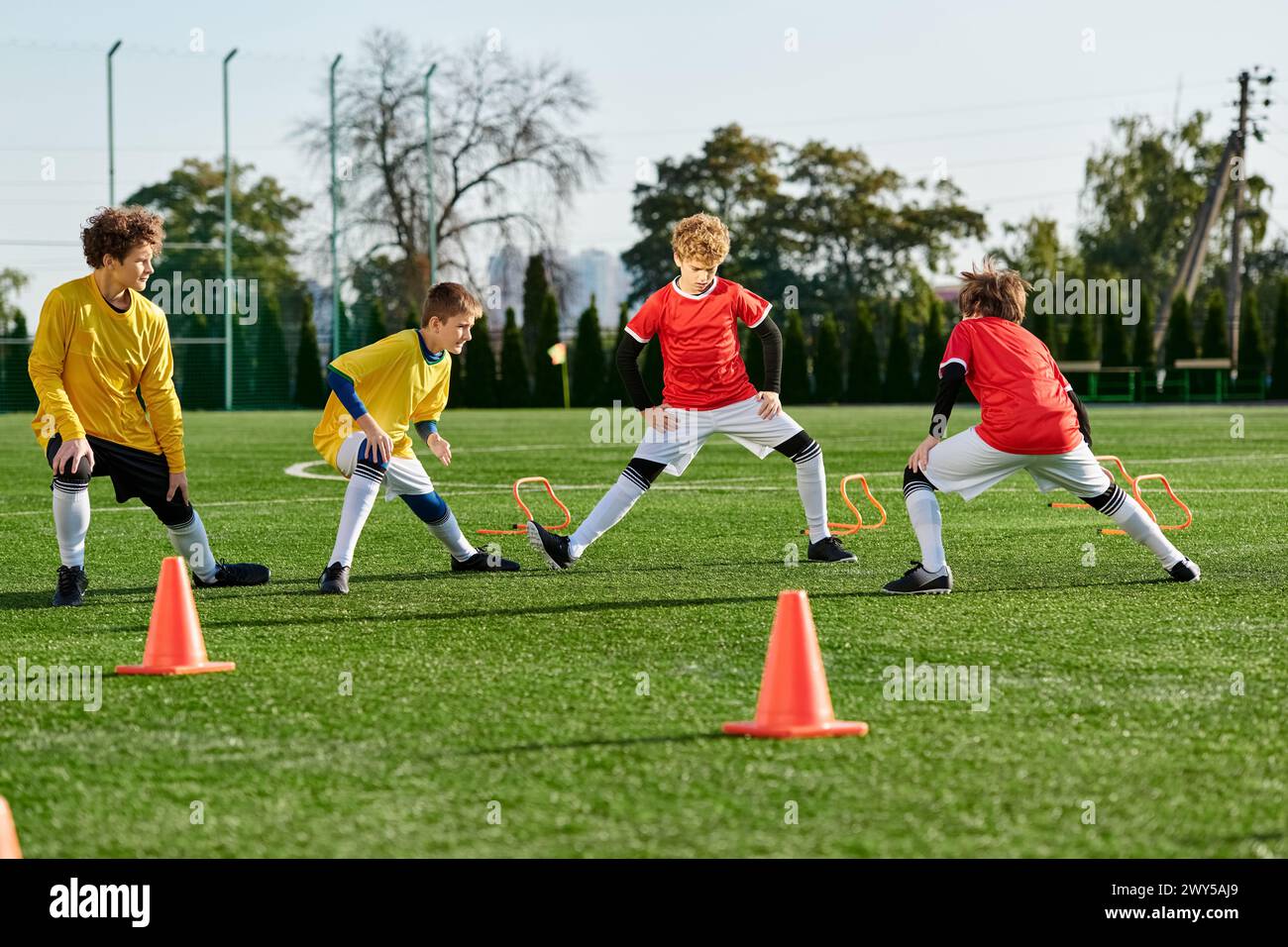 A group of young men running and jumping in a park while playing an ...