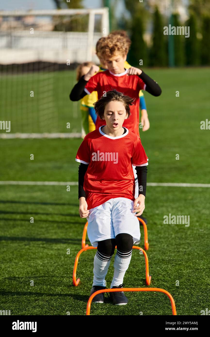 Young children energetically play a game of soccer, running, kicking ...