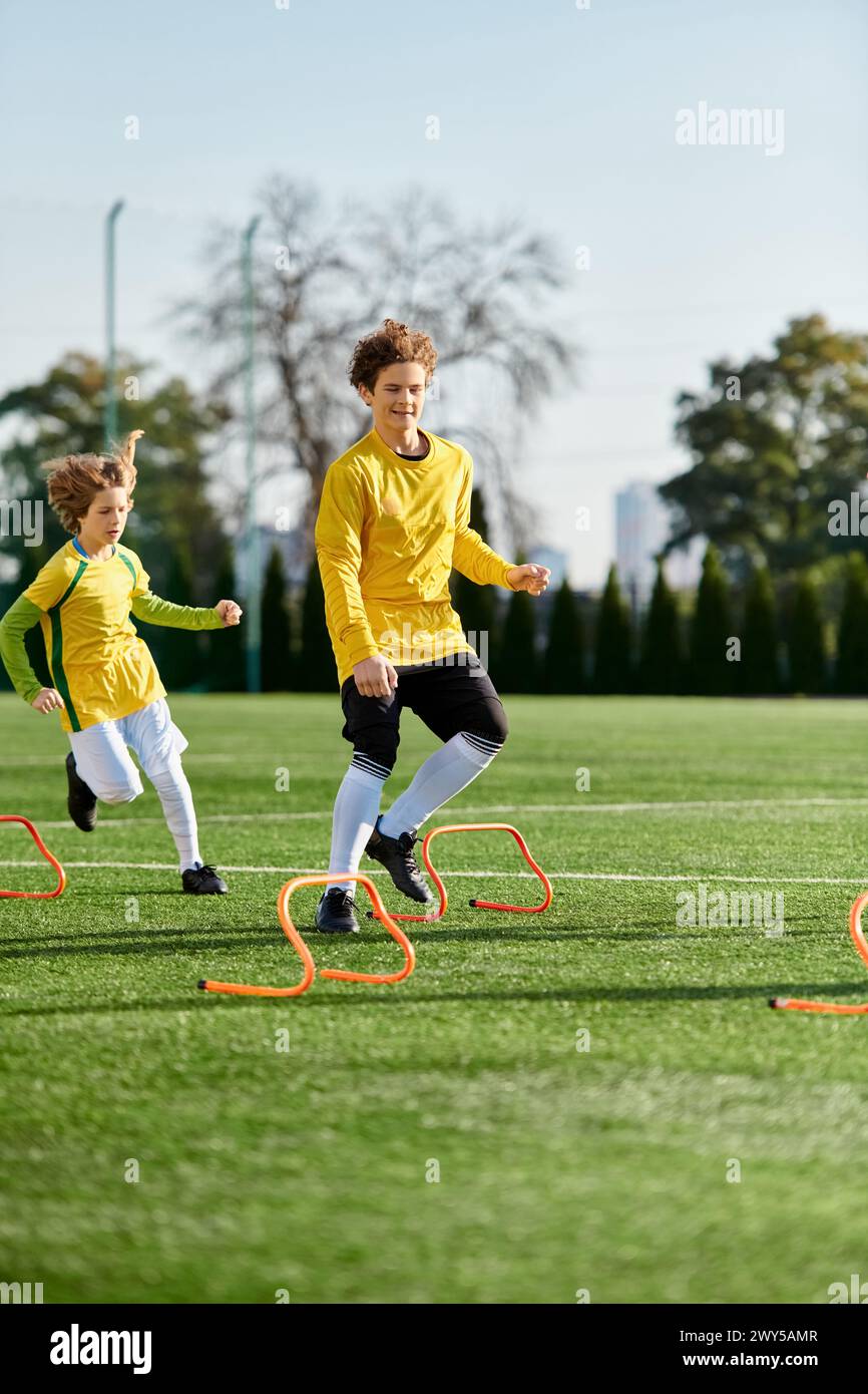 A group of young men engaged in a spirited game of soccer, running ...