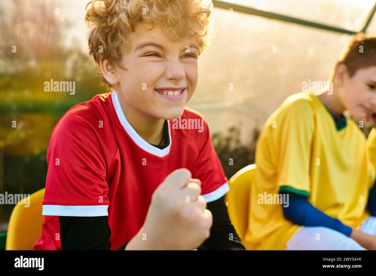 Two young men are sitting closely next to each other, engaged in deep ...