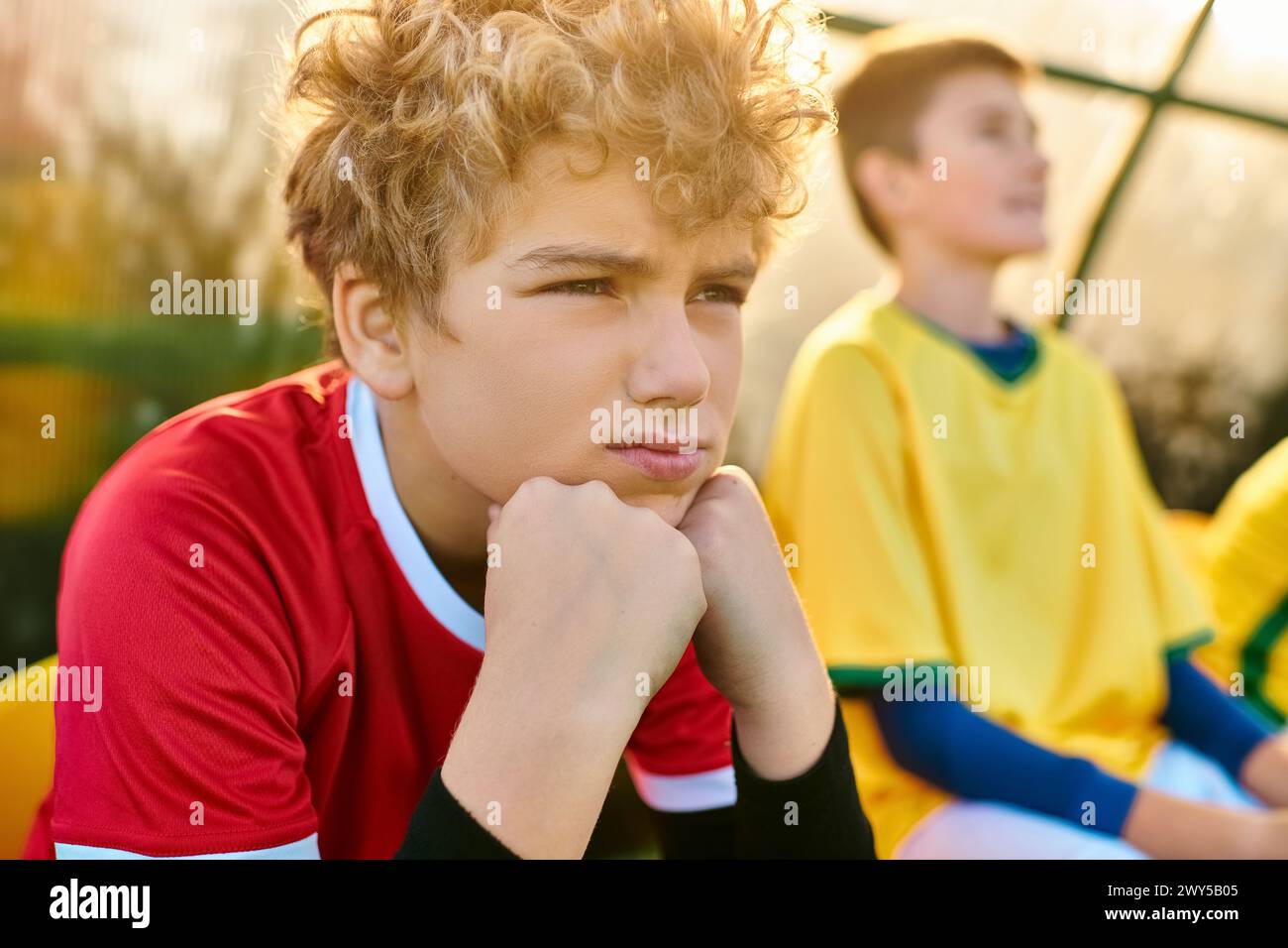 Two young men are seated closely together, engrossed in conversation ...