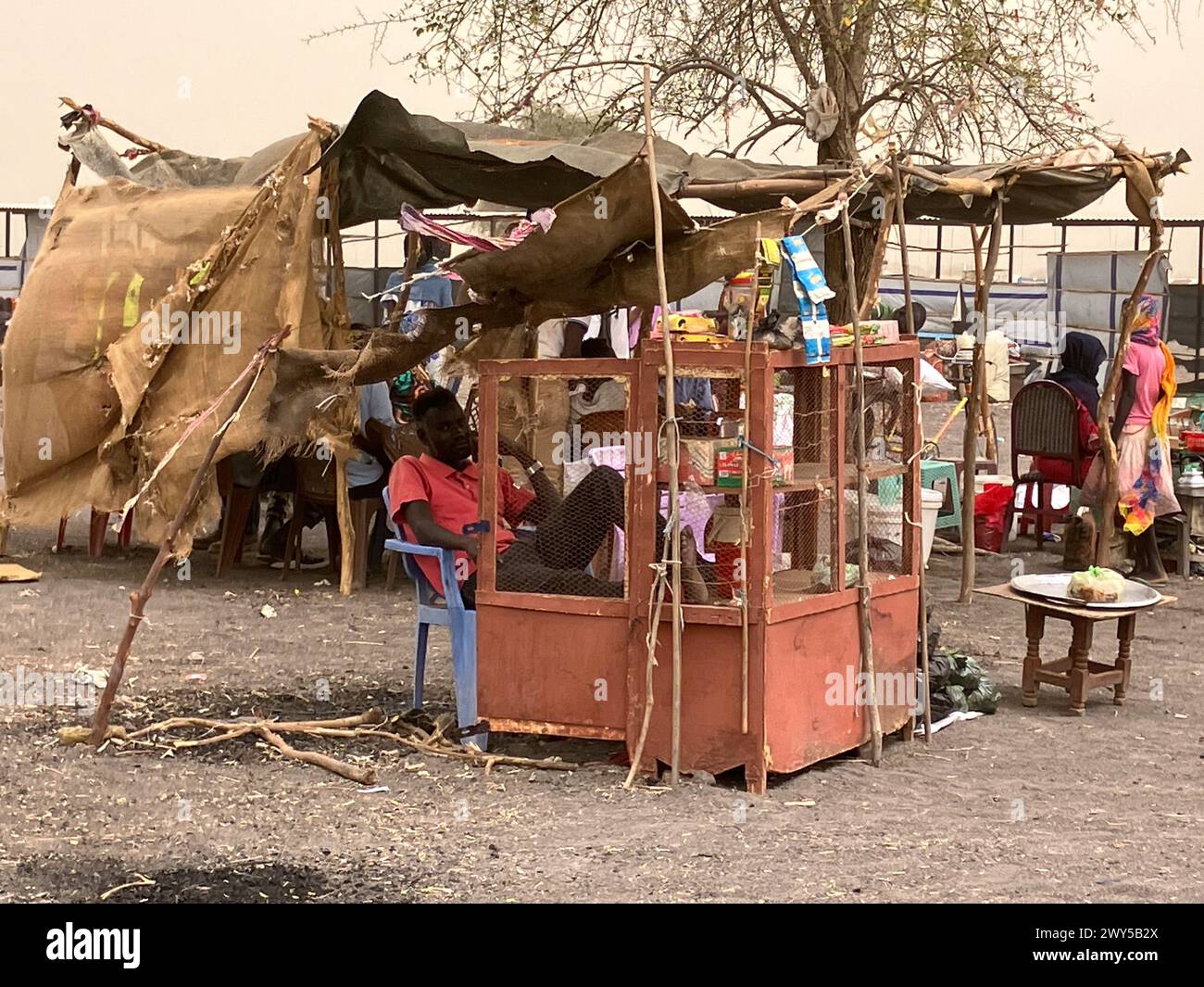PRODUCTION - 19 March 2024, South Sudan, Renk: A man waits for ...