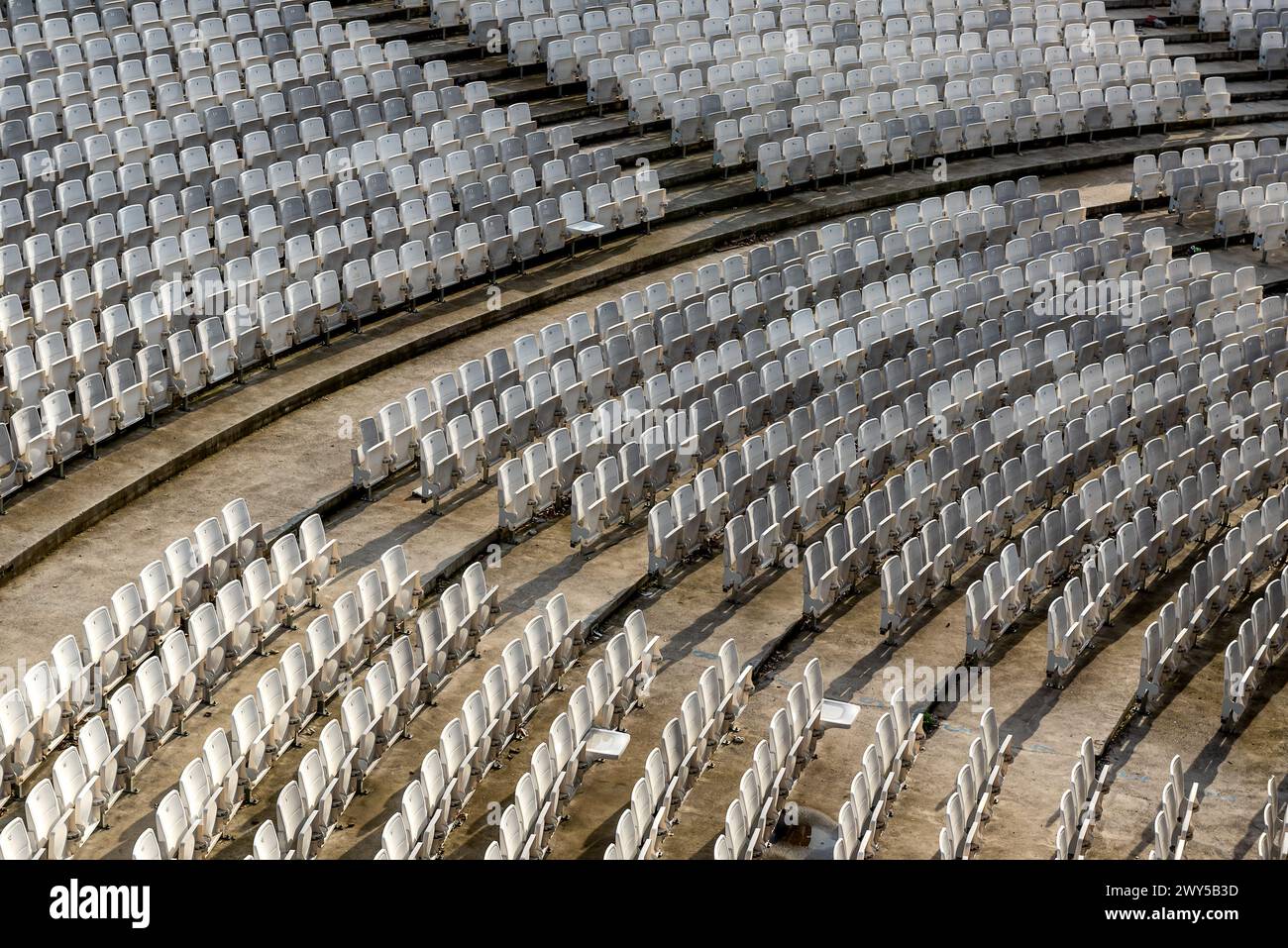 White seats in rows in empty amphitheatre auditorium outdoors. Empty ...