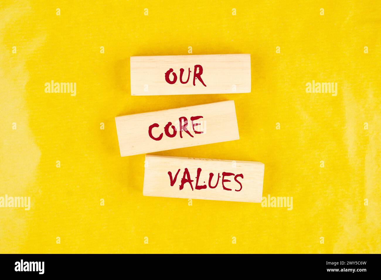 Concept words OUR CORE VALUES symbol on wooden blocks on a yellow ...