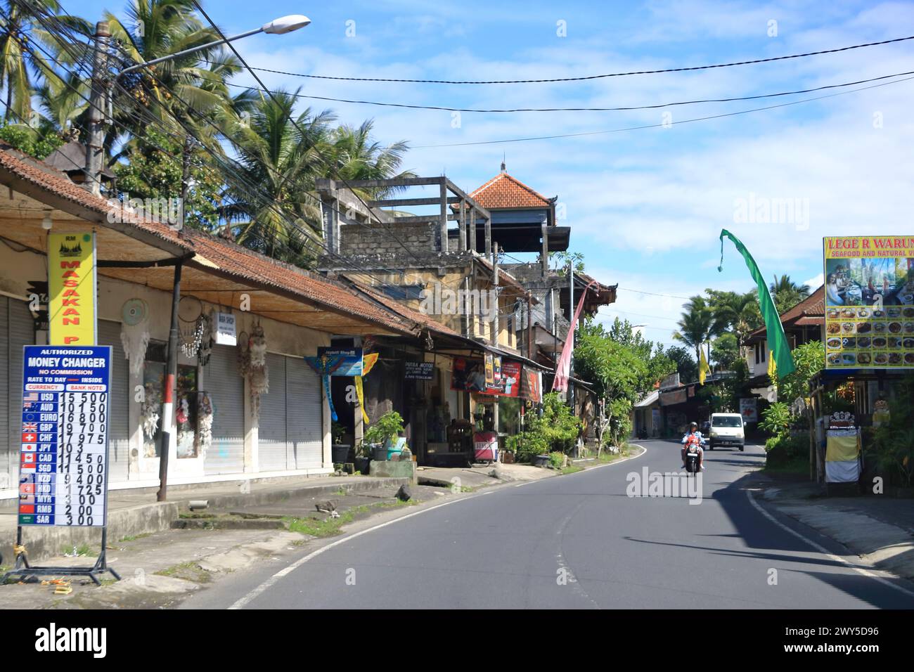 Ubud, Bali in Indonesia - January 31 2024: Cars and motobikes drive on ...