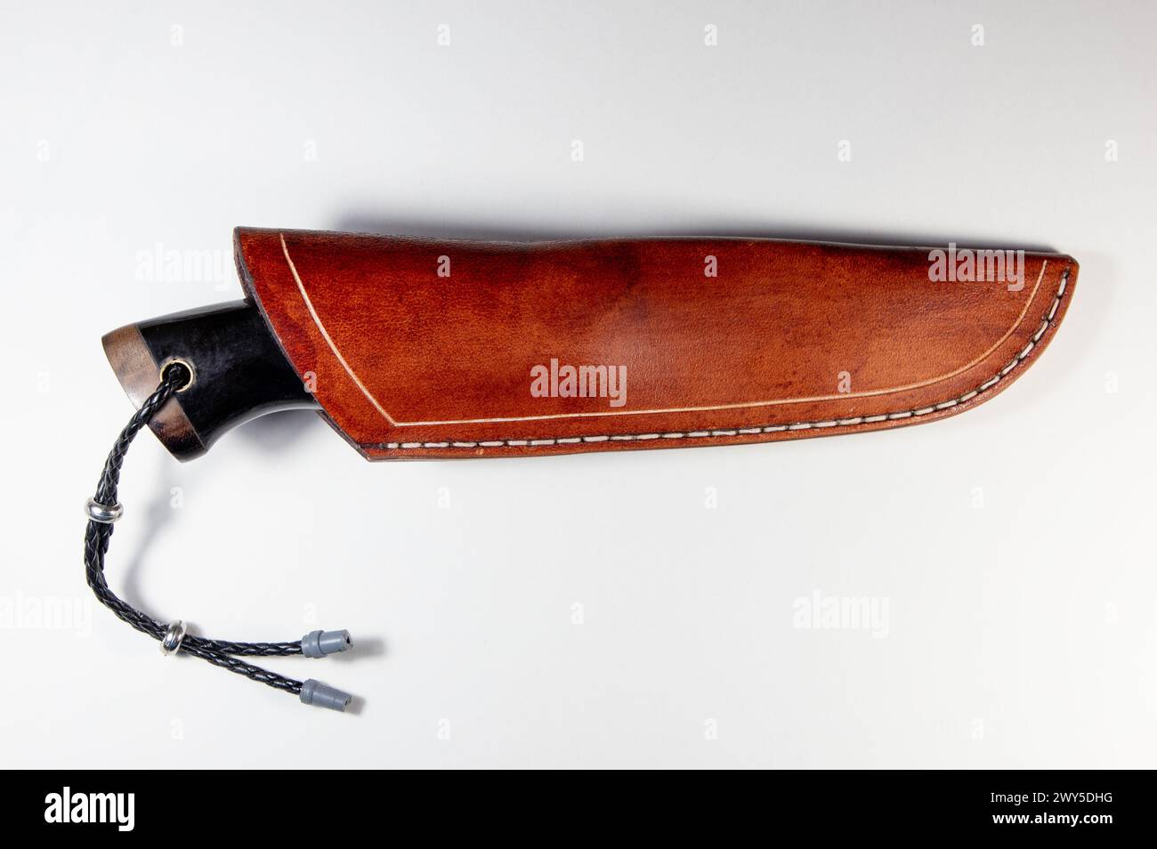 Leather knife case and string on white background Stock Photo - Alamy