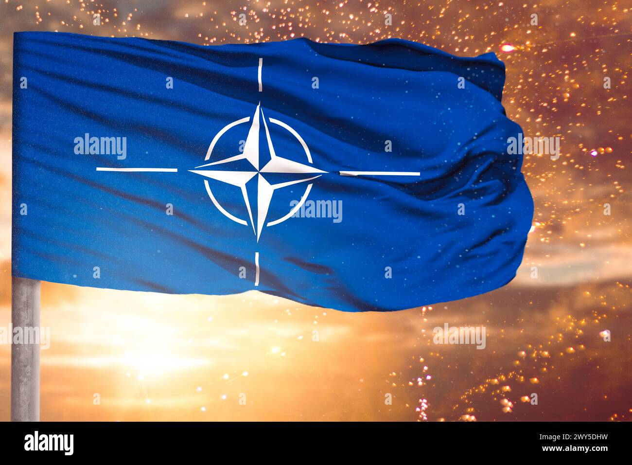 4 April 2024: Fire and sparks around a NATO flag. Symbolic image of war ...