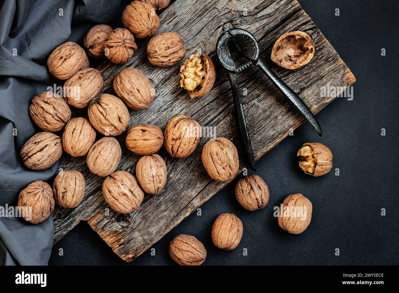 Ripe and raw whole big walnut kernel with shell on rustic backdrop ...