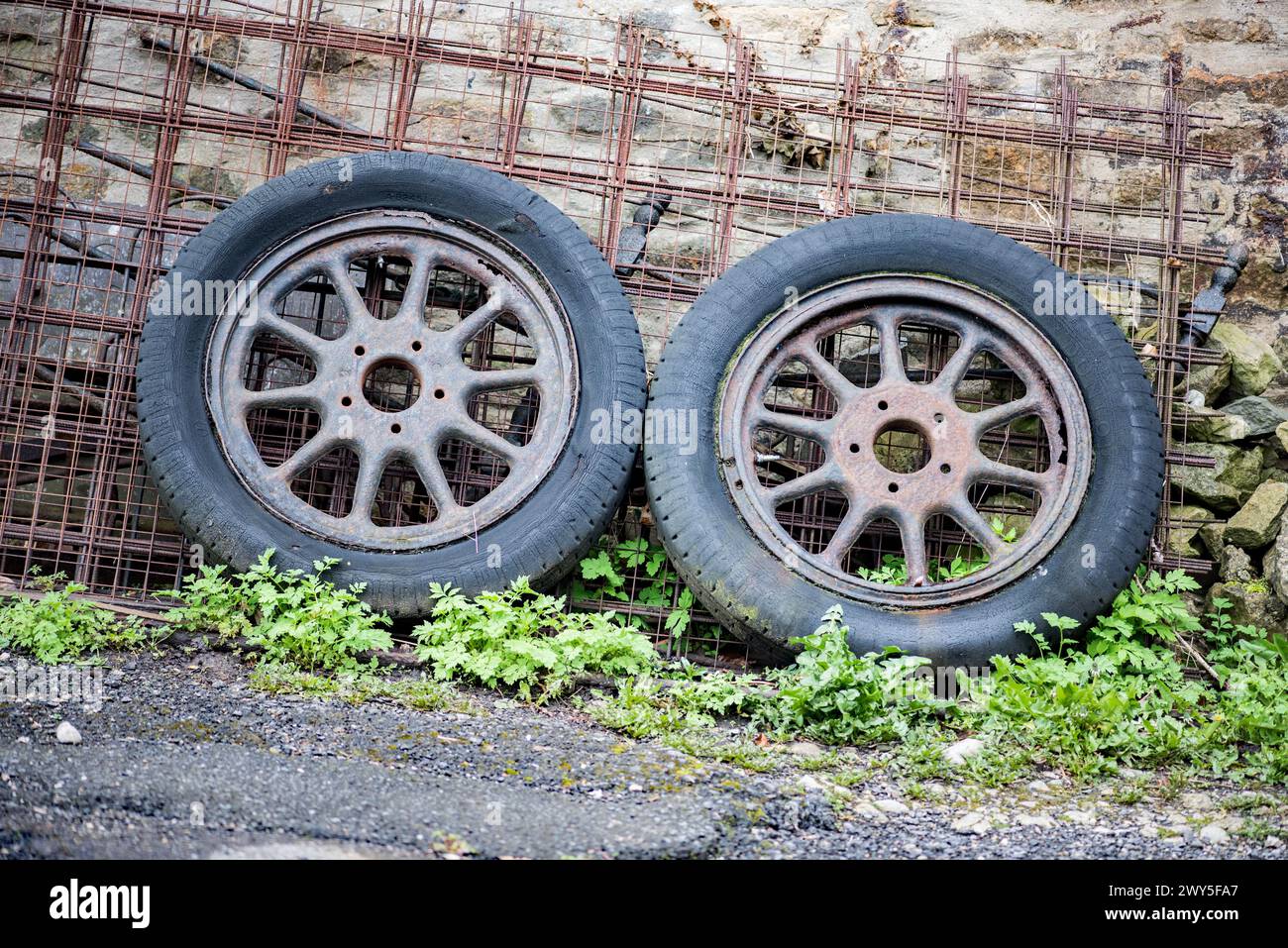 Rusting spoked wheels outside Settle blacksmiths premises Stock Photo - Alamy
