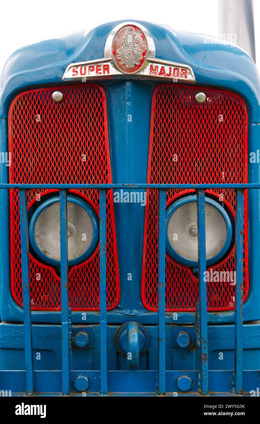 Front view of the grille of an old Super Major tractor painted red and ...
