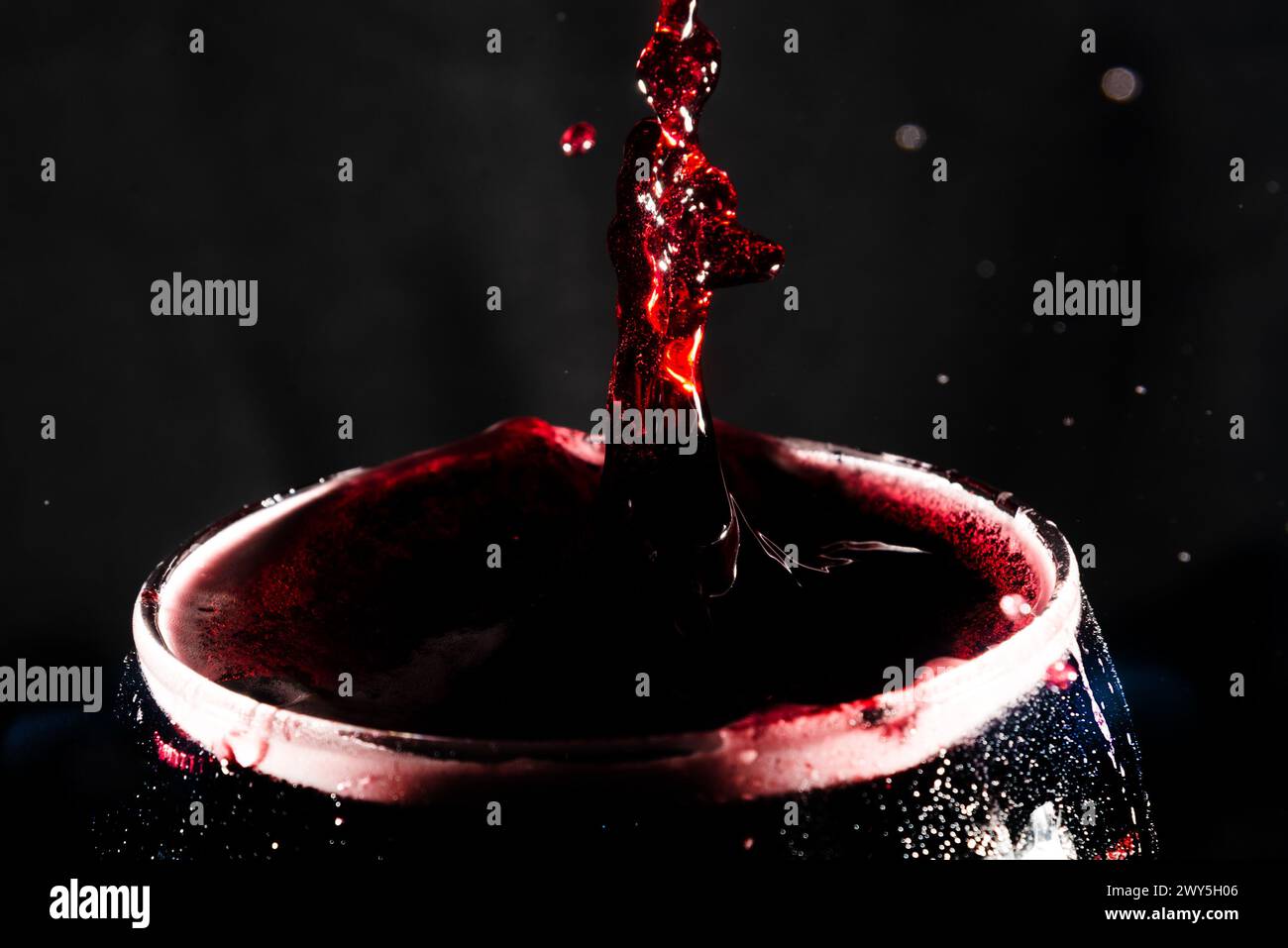 Close-up of the top of a clear glass goblet filled with wine with ...