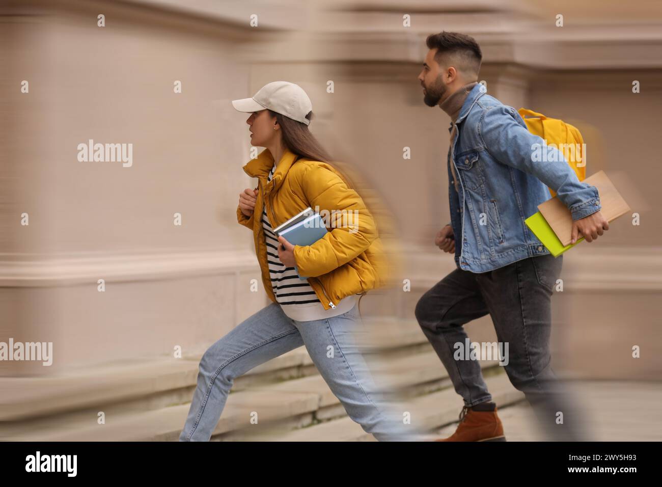 Being late. Students running for class outdoors. Motion blur effect ...
