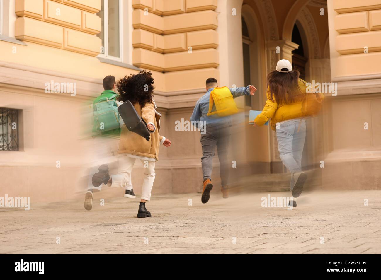 Being late. Group of students running for class. Motion blur effect ...