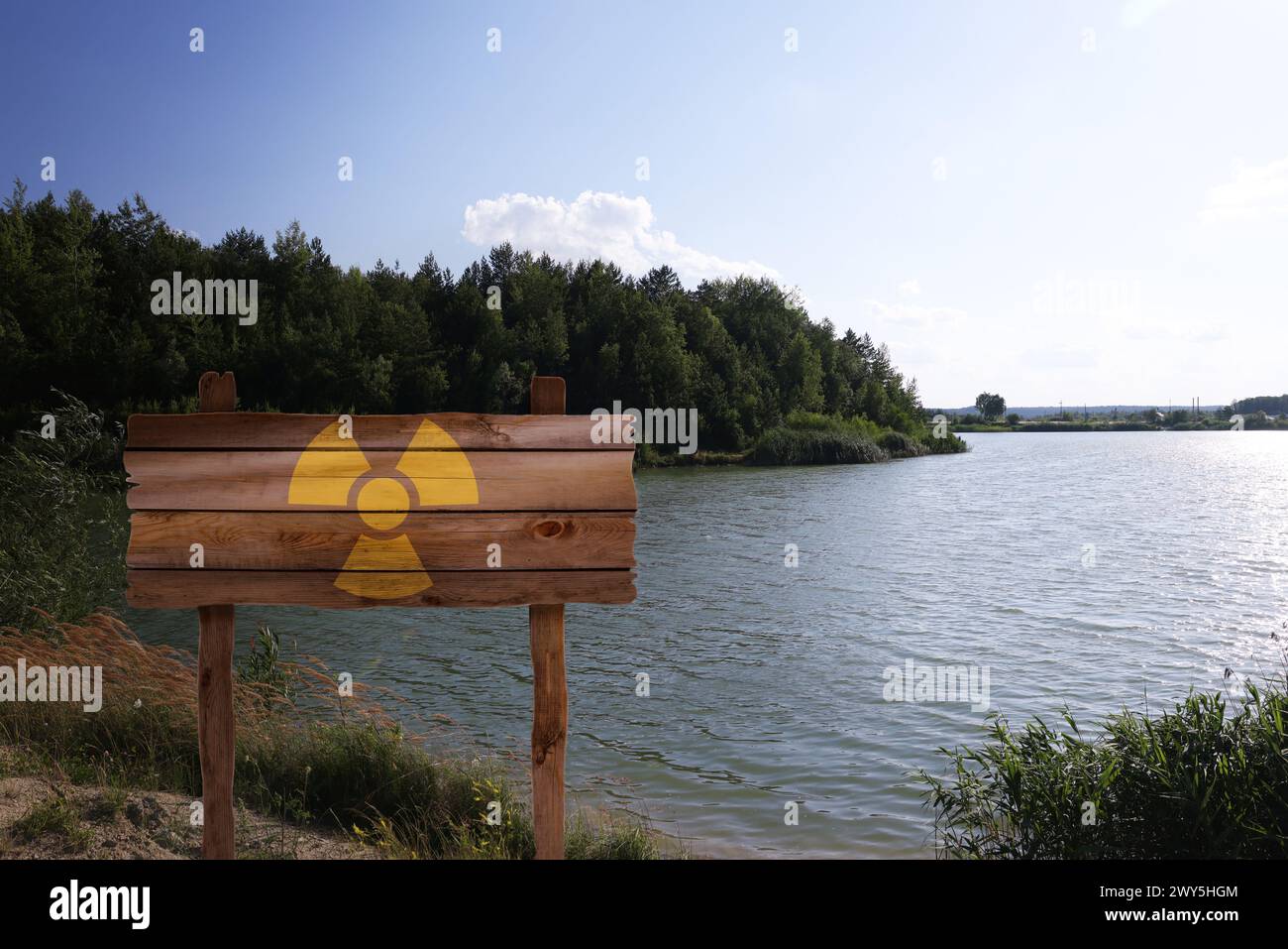 Radioactive pollution. Yellow warning sign with hazard symbol near ...