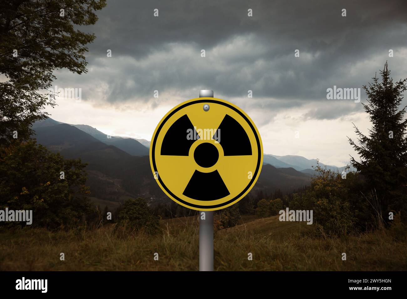 Radioactive pollution. Yellow warning sign with hazard symbol in ...