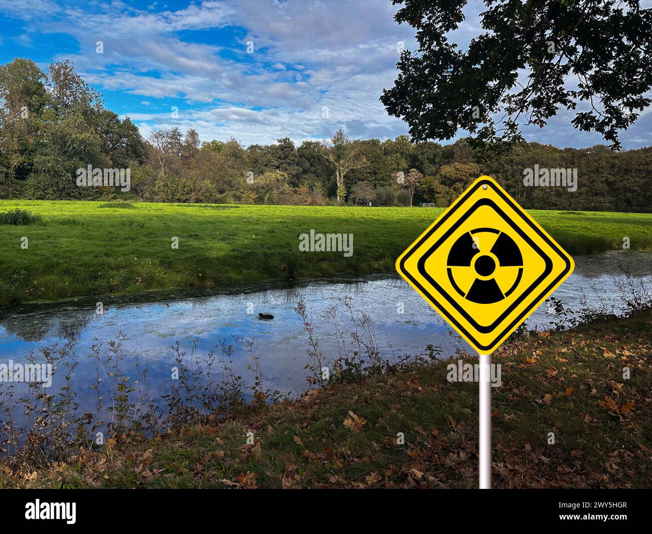 Radioactive pollution. Yellow warning sign with hazard symbol near ...