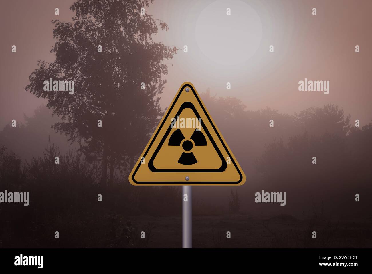 Radioactive pollution. Yellow warning sign with hazard symbol in rural ...