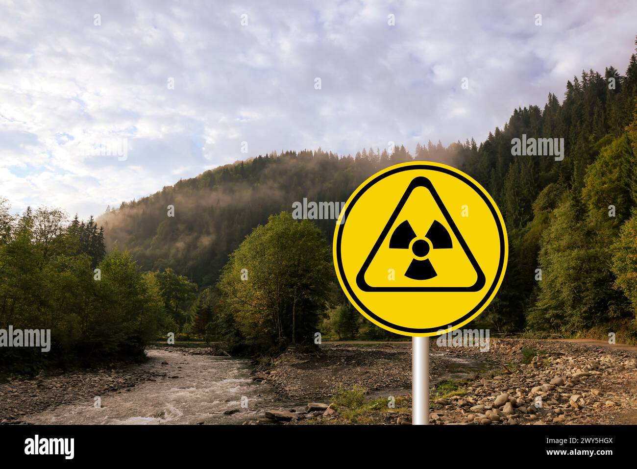 Radioactive pollution. Yellow warning sign with hazard symbol in ...