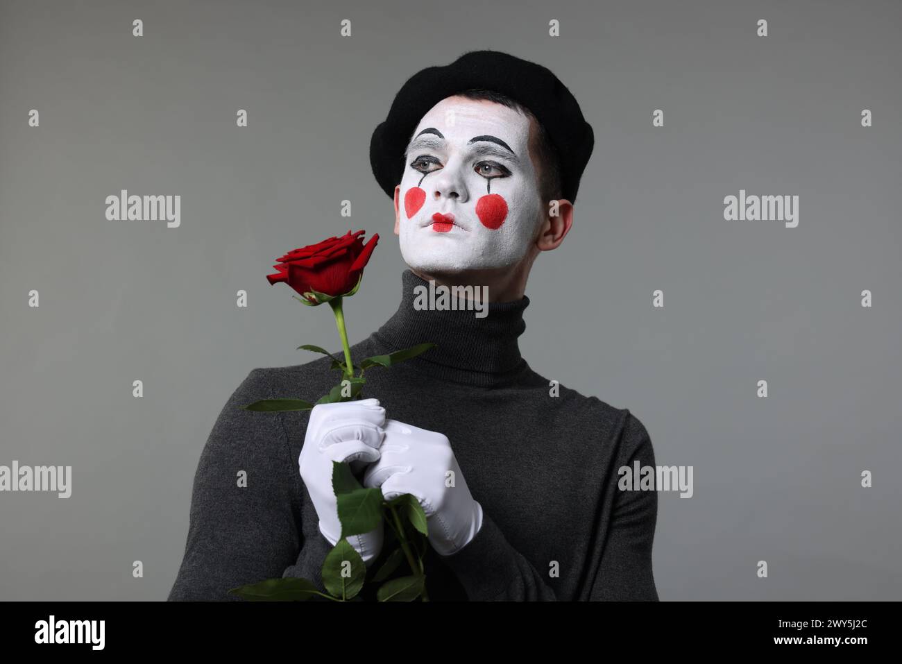 Portrait of mime artist with red rose on grey background Stock Photo ...