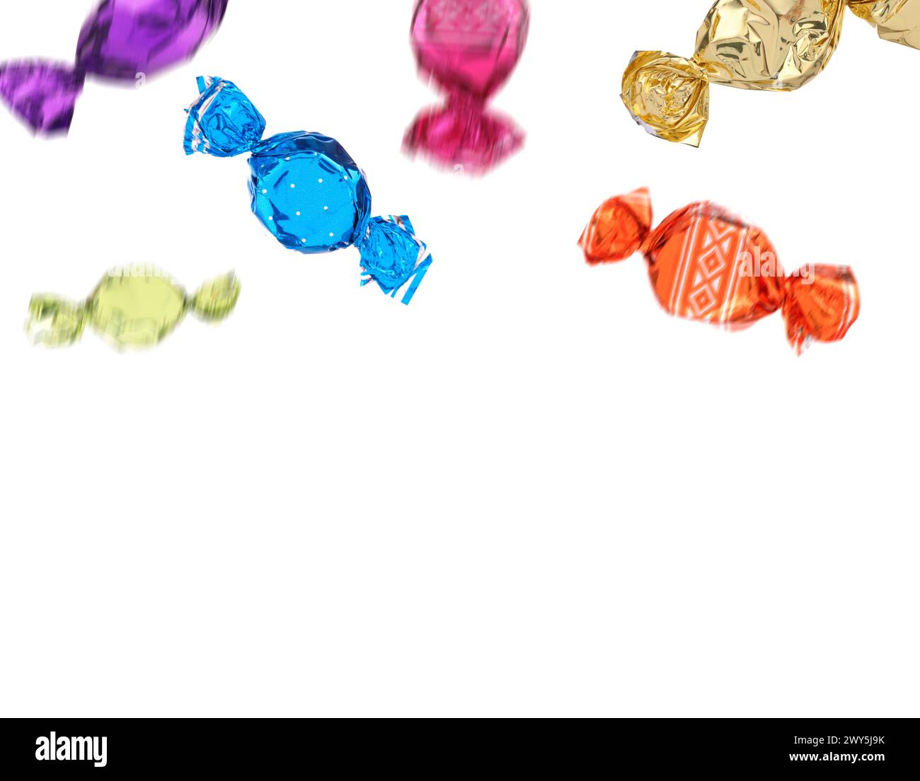 Candies in bright wrappers falling on white background Stock Photo - Alamy
