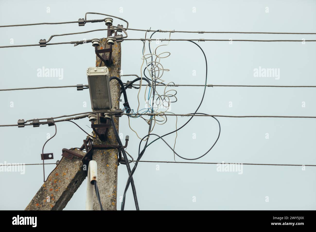 Concrete rural pillar with numerous electrical wires and connectors ...