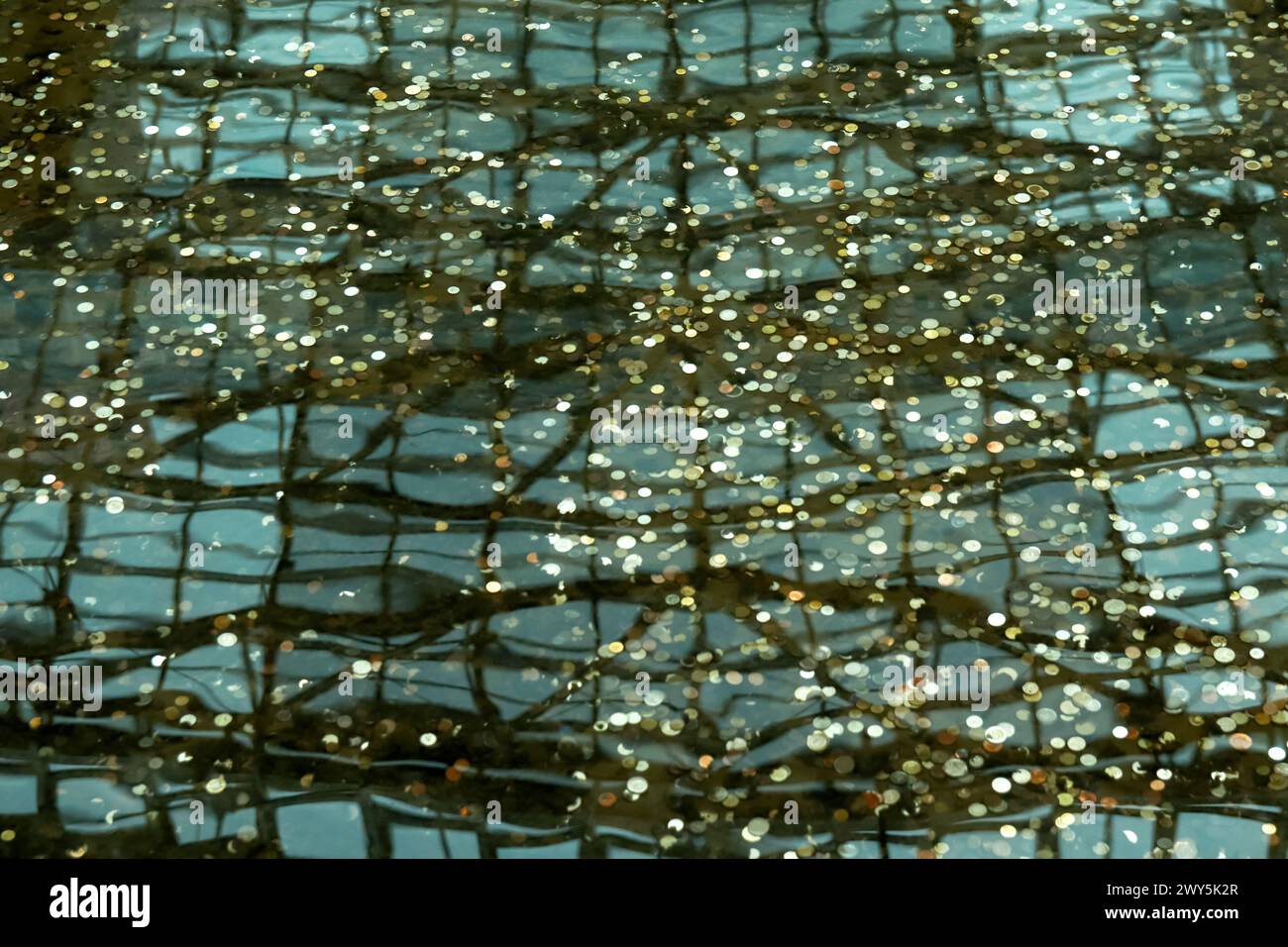 Fountain with water cascading over pennies and coins, symbolizing luck ...