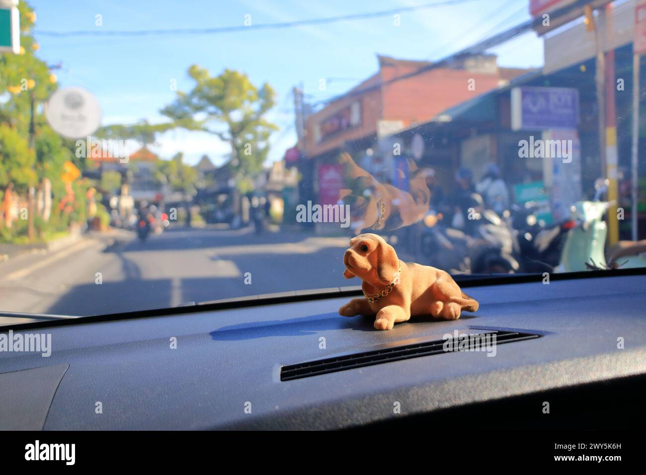 Ubud, Bali in Indonesia - January 31 2024: Cars and motobikes drive on ...