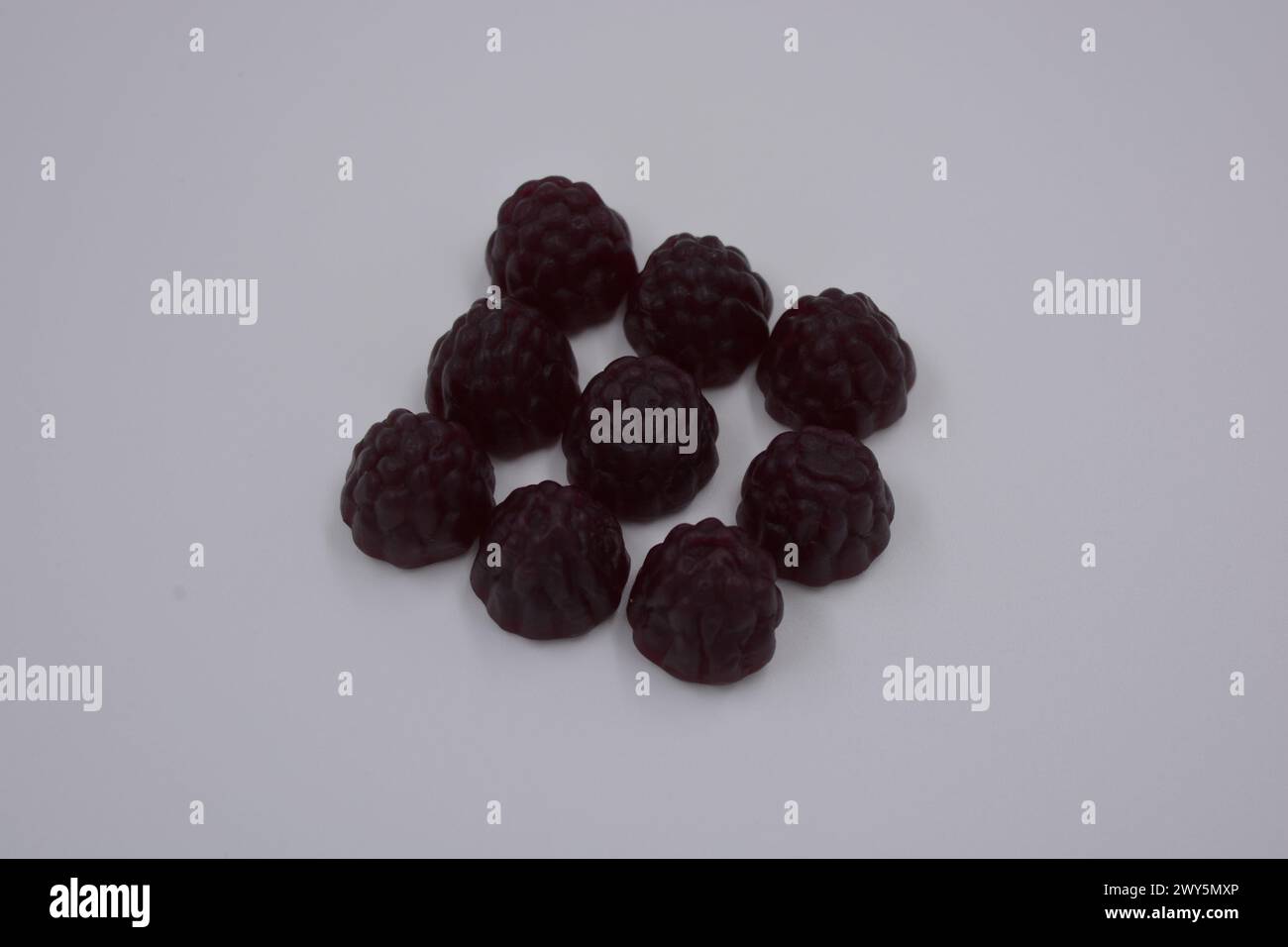 Unusual sweets, colored jelly candies in the form of fruits. Black ...