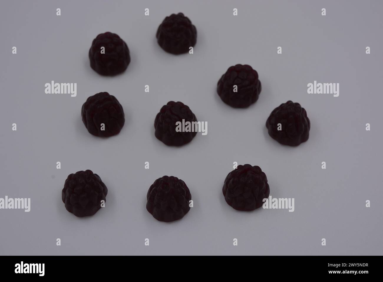 Unusual sweets, colored jelly candies in the form of fruits. Black ...