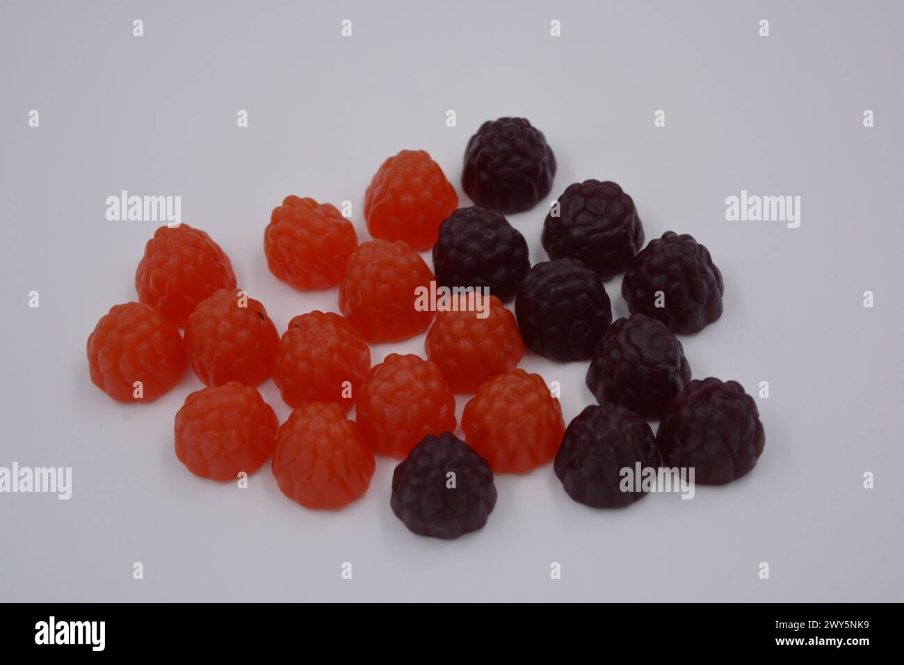 Unusual sweets, colored jelly candies in the form of fruits. Red, black ...
