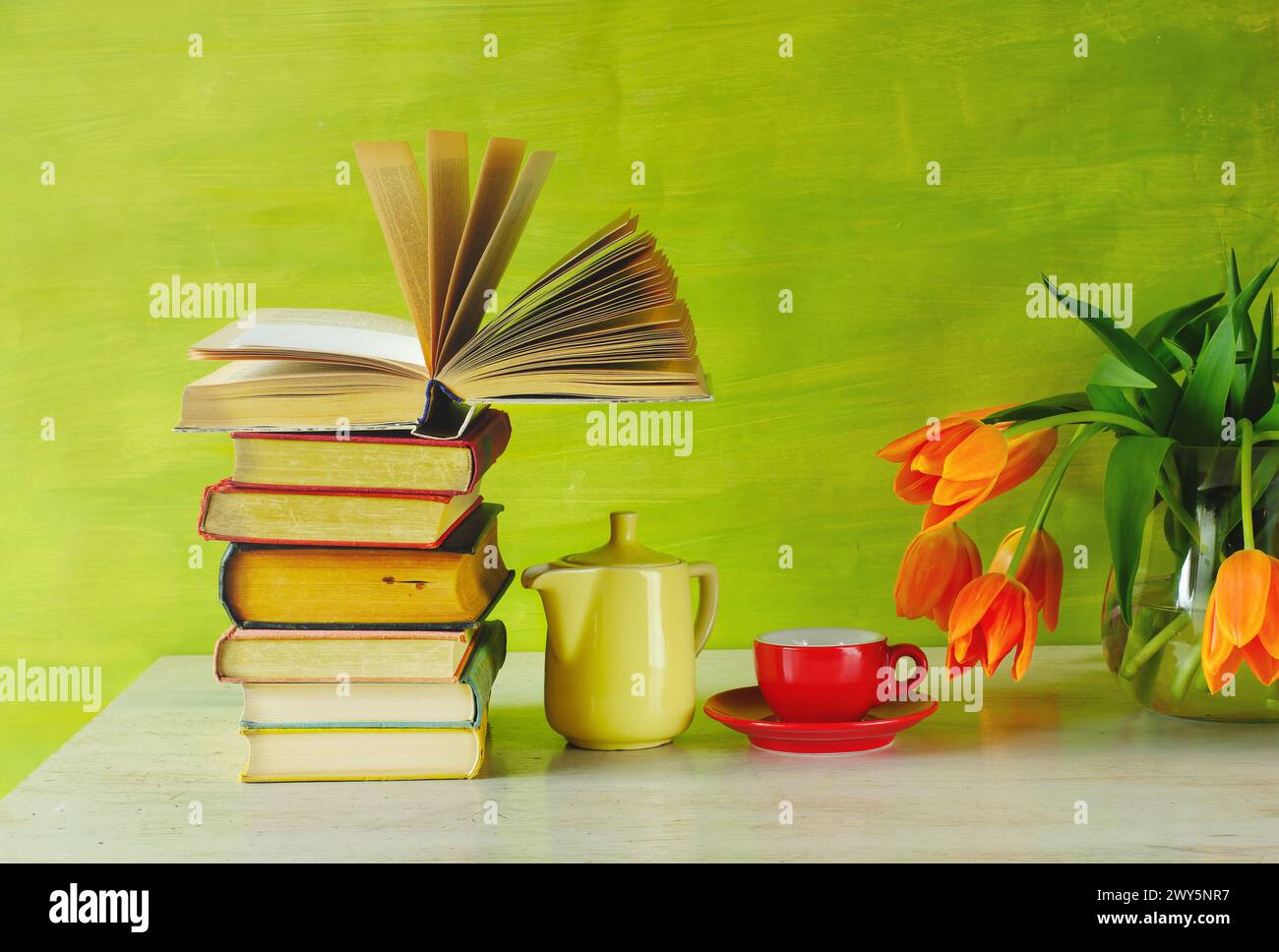 Stack of books with open book, cup of espresso coffee and a bunch of ...