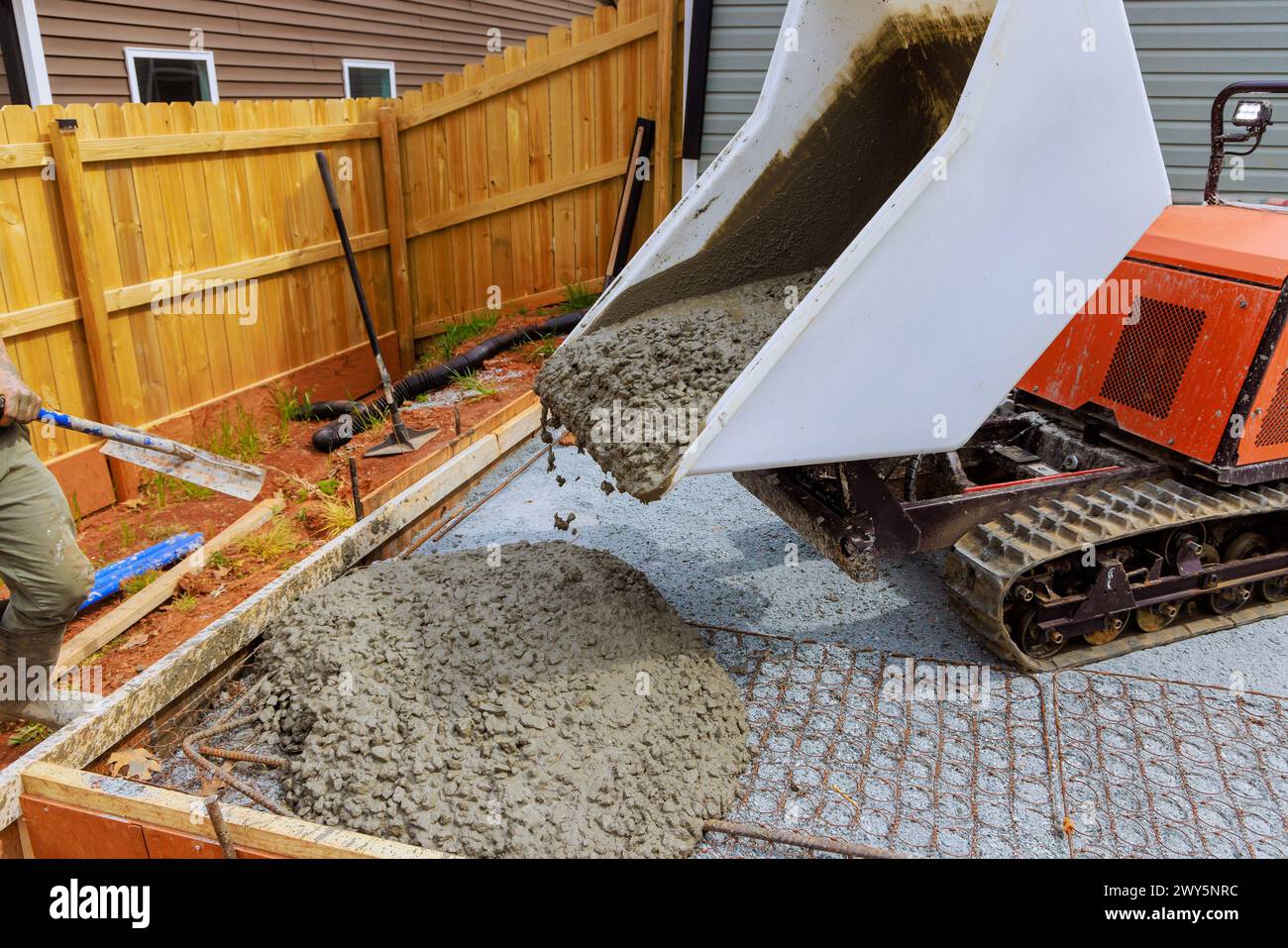 Construction of foundation involves pouring of wet cement into ...