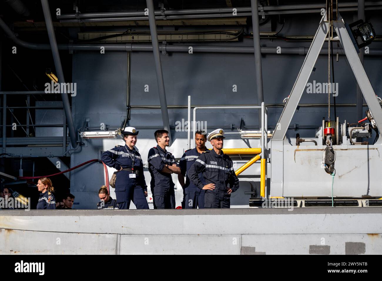 Sailors wait to be reunited with their families during the docking of ...