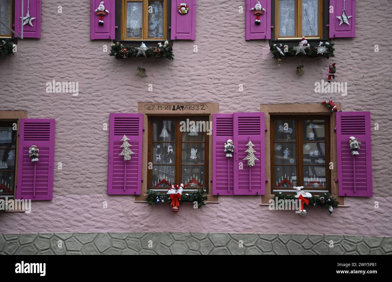 Rural Alsatian house facade with a pink textured wall and fuchsia ...