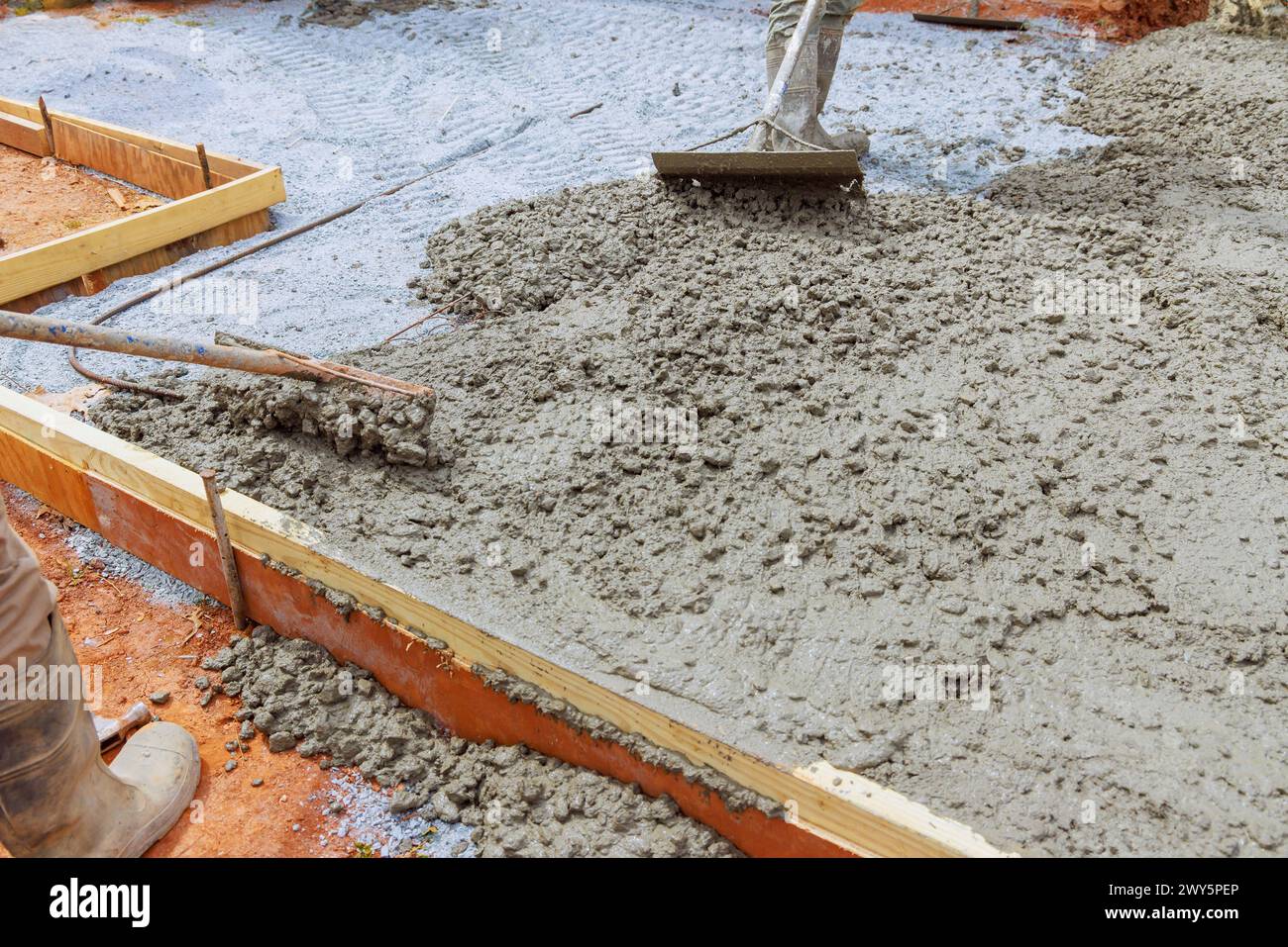 Concrete is leveled by construction worker using special tool Stock ...