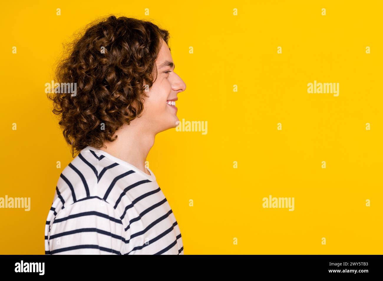 Side profile photo of young smiling wavy curls hair model looking empty ...