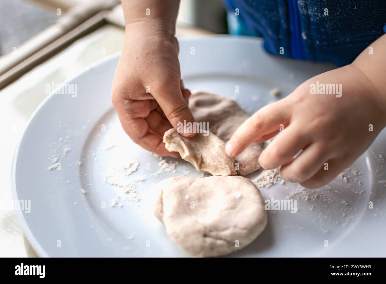 Child having fun modeling dough, authentic activity for fine motor ...